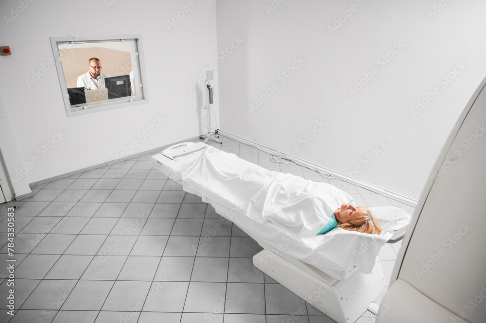 Medical computed tomography or MRI scanner. Female patient lying on ...