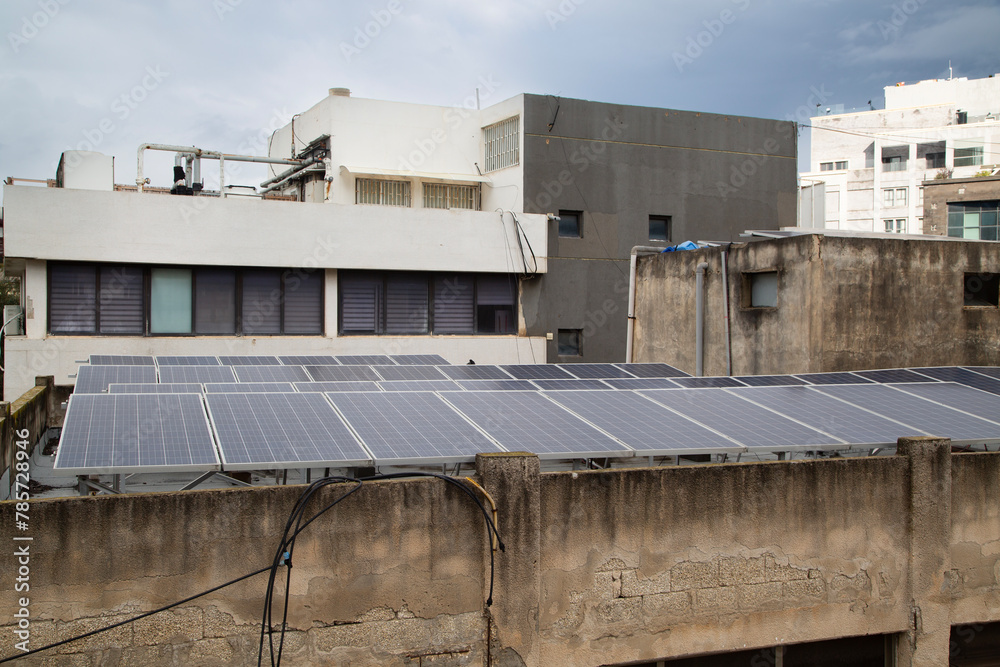 Urban solar panels on building rooftops in Ramat Gan, Israel, under ...