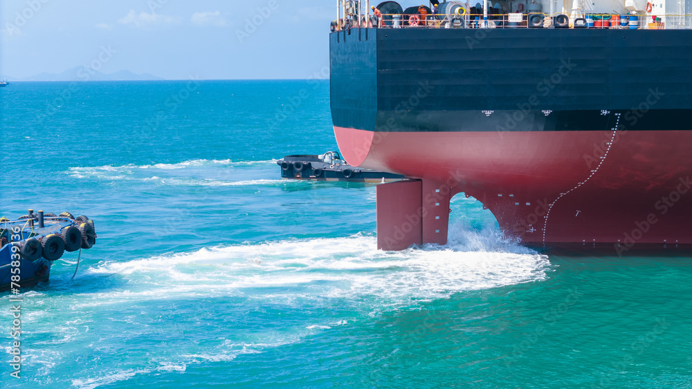 Propeller of large ship spinning power working and water splash ...