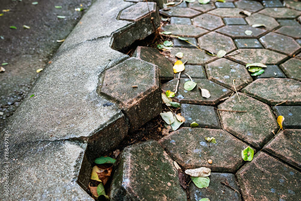 Pavement surface is damaged and dangerous. Broken brick blocks can pose ...