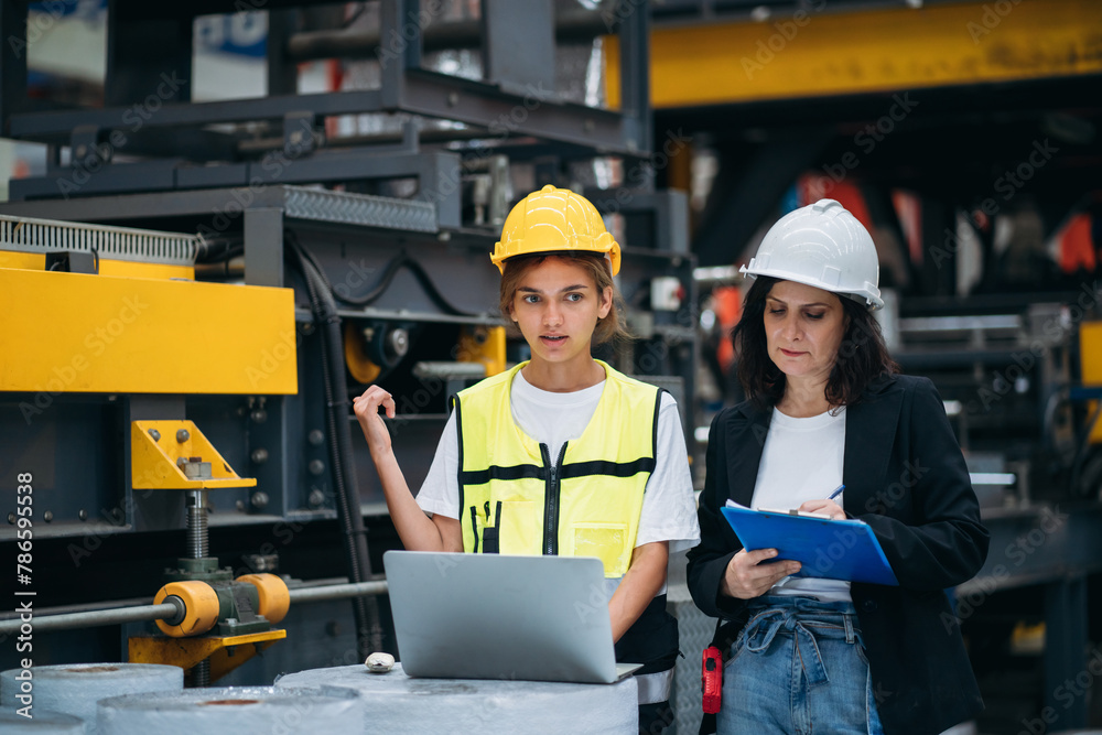 Industrial worker inspecting and check up machine at factory machines ...