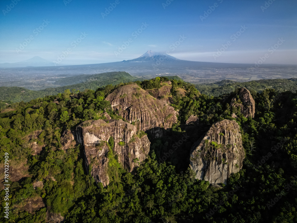 Mount Merapi seen afar from the peak of the Nglanggeran Ancient Volcano ...