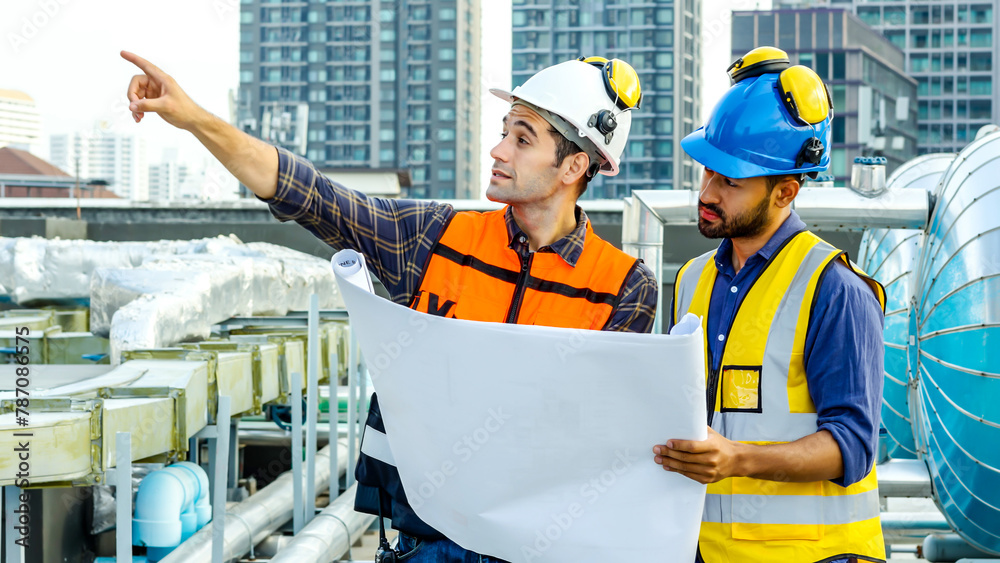 Contractor, Two civil engineers checking information from blueprint ...