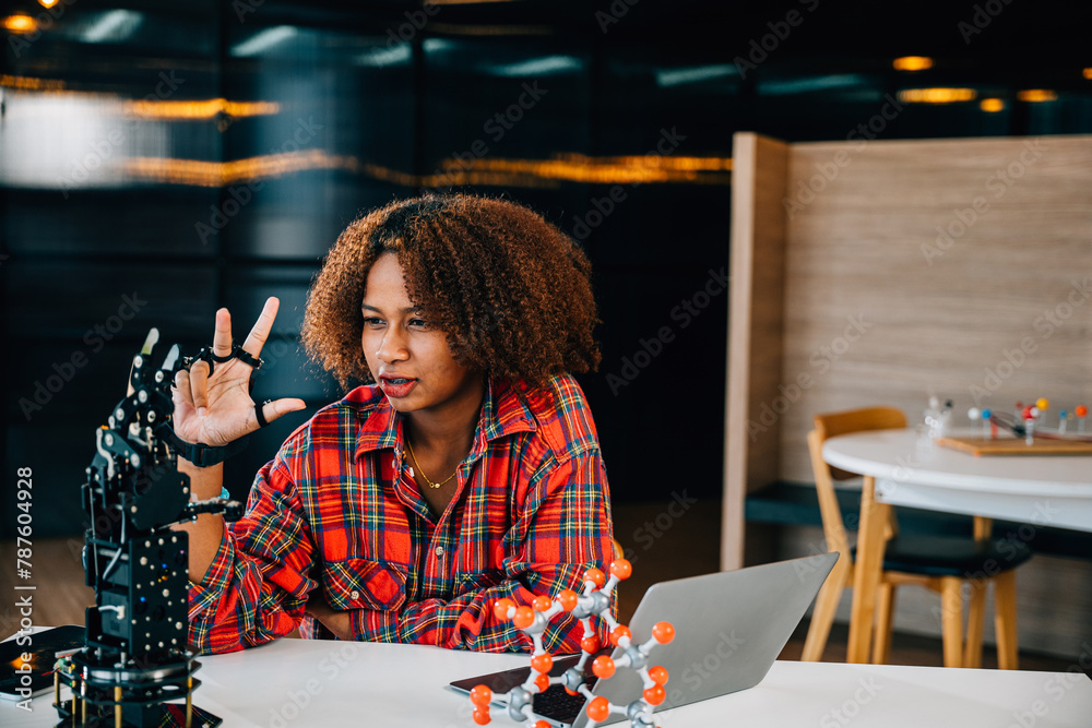 In a classroom a smart teenager experiments with a humanoid robotic ...