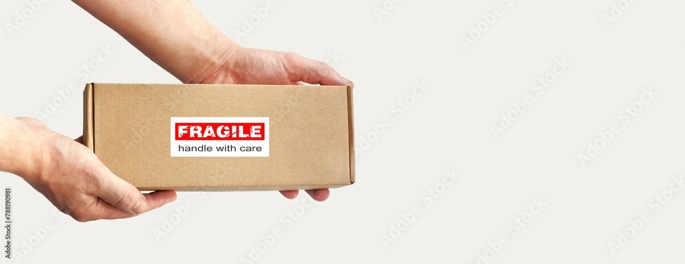 One rectangular cardboard box in hands for fragile items packing on a ...