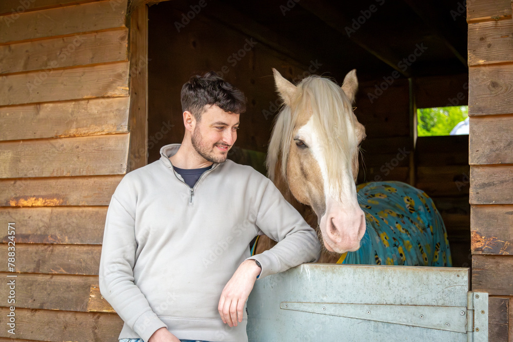 Man with a horse, Image shows a 28 year old bearded male posing with a ...