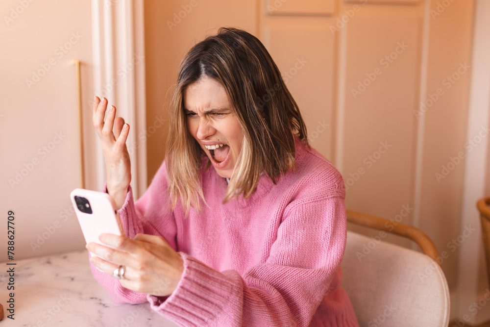 Beautiful upset woman sitting alone near big window in coffee shop ...