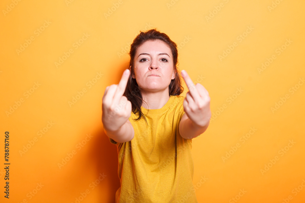 Confident brunette woman doing aggressive, vulgar hand gestures against ...