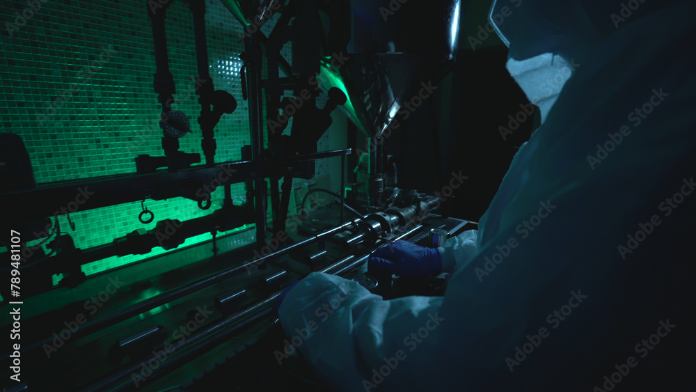 Person operates buttons that control pressure in nuclear reactor tubes ...