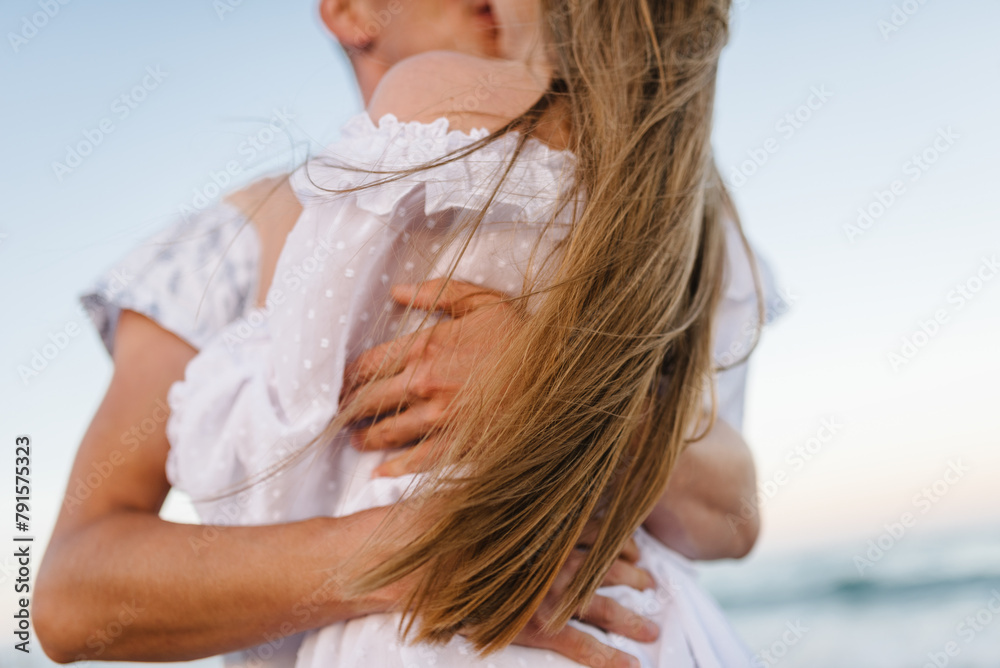 Foto de Stock Couple in love hugging on seashore closeup. Female hugs ...