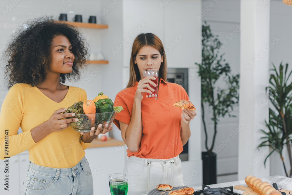 Two women choosing between vegetable and sausage, organic food vs gmo ...