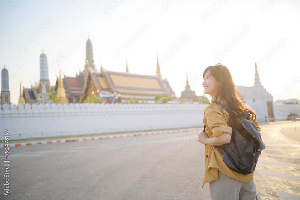 Traveler asian woman in her 30s, backpack slung over her shoulder ...