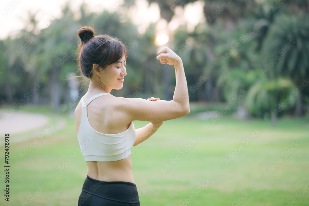 Strong fitness asian woman runner showing off muscular arms flexing ...