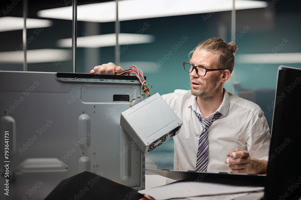 Portrait of sad minded man unable to repair his broken office pc ...