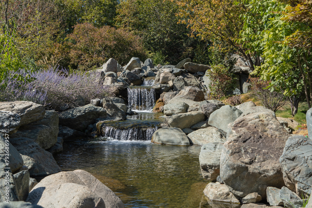 Triple waterfall in the Japanese Garden. Water falls from a height of 7 ...