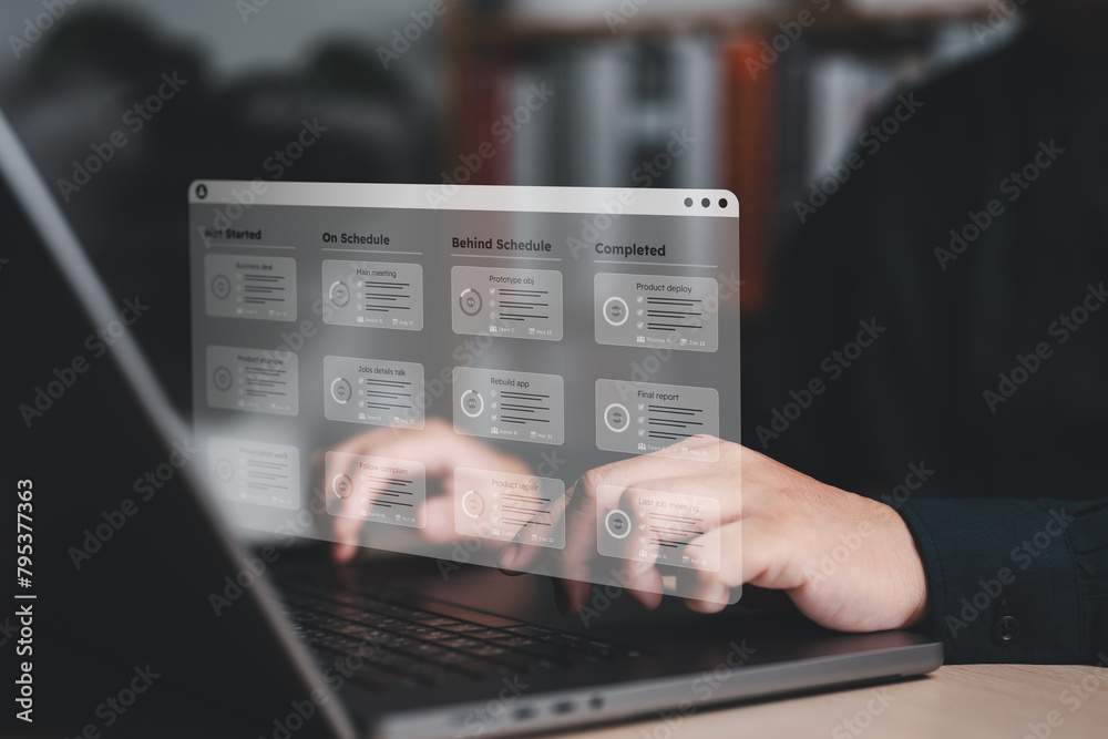 Project manager or handler uses a laptop to manage project progress ...