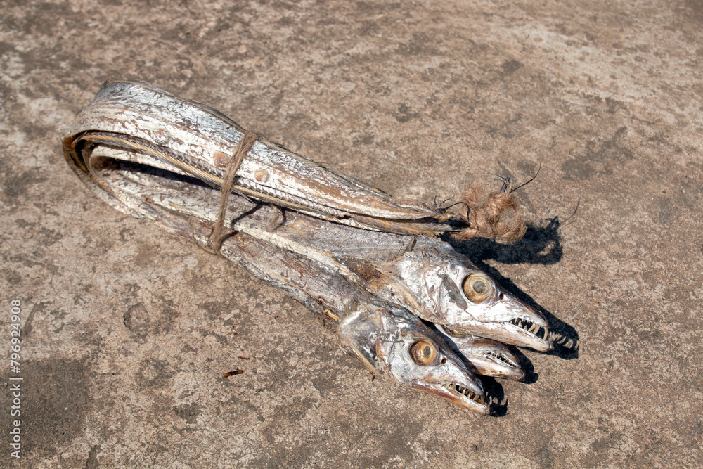 asian ribbon fish or hairtail on rugh background. Dried sea fish from ...