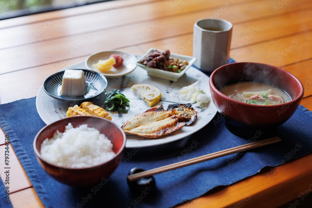 Japanese breakfast includes grilled fish, miso soup, tofu, rice ...