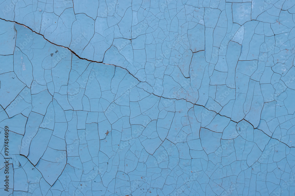 Blue peeling paint on the wall. Old concrete wall with cracked flaking ...