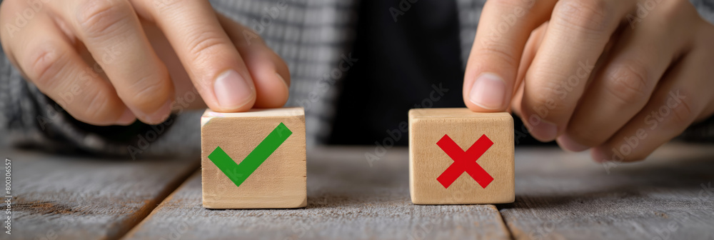 Hands selecting between wooden blocks with green checkmark and red ...