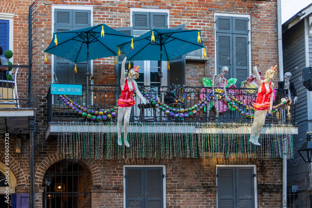 Mardi Gras decorations with beads and blow up dolls on a balcony of a ...