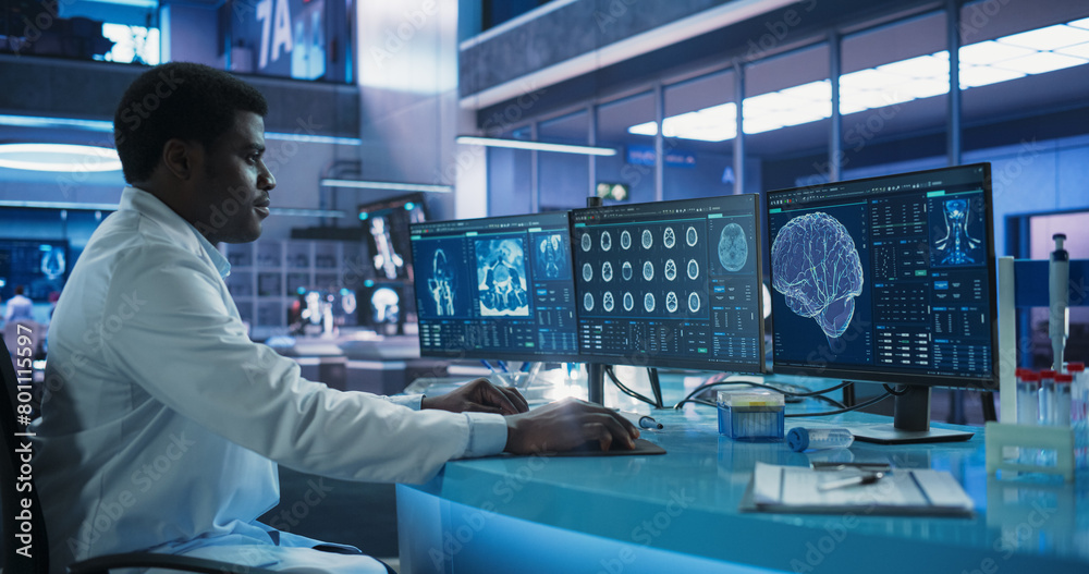 Black Male Neuroscientist Using Desktop Computer To Analyze MRI Scans ...