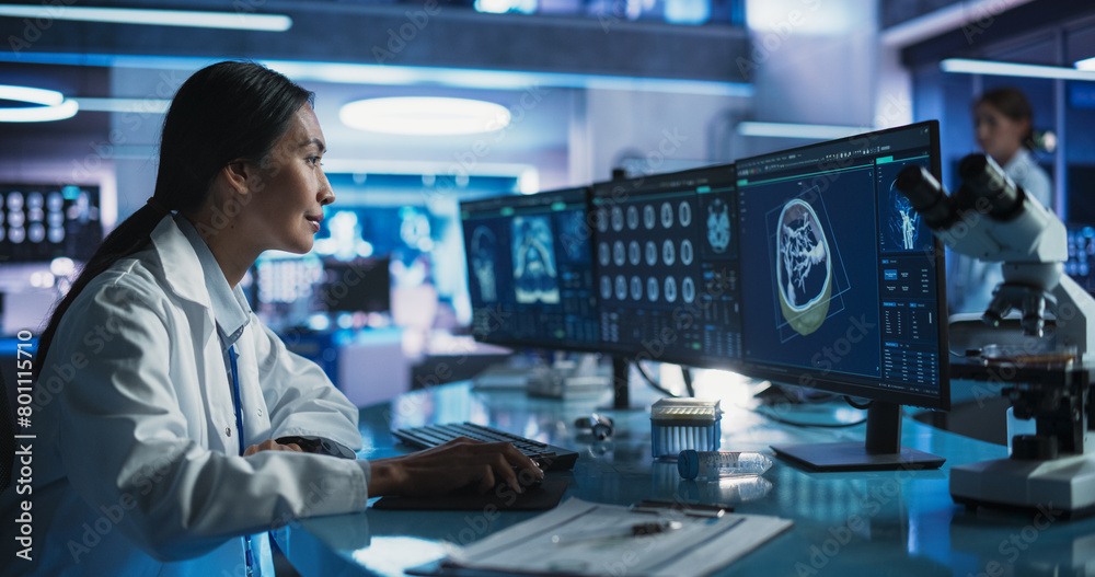 Female Asian Neuroscientist Using Desktop Computer With Human Brain CT Scans In Modern Medical ...