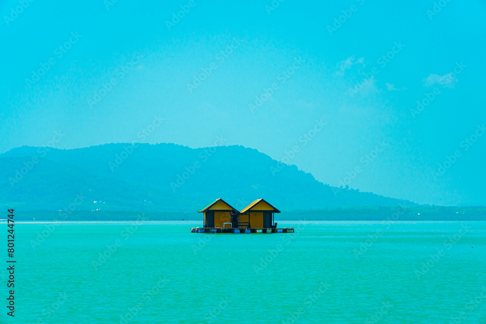 Small floating houses between the horizon line that separates the sea ...