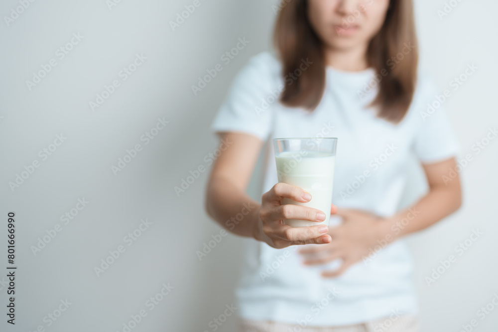Lactose intolerance and Milk allergy concept. woman hold Milk glass and having abdominal cramps ...