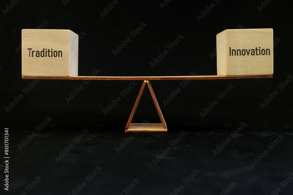 Balance tradition and innovation concept. Wooden blocks on a scale ...