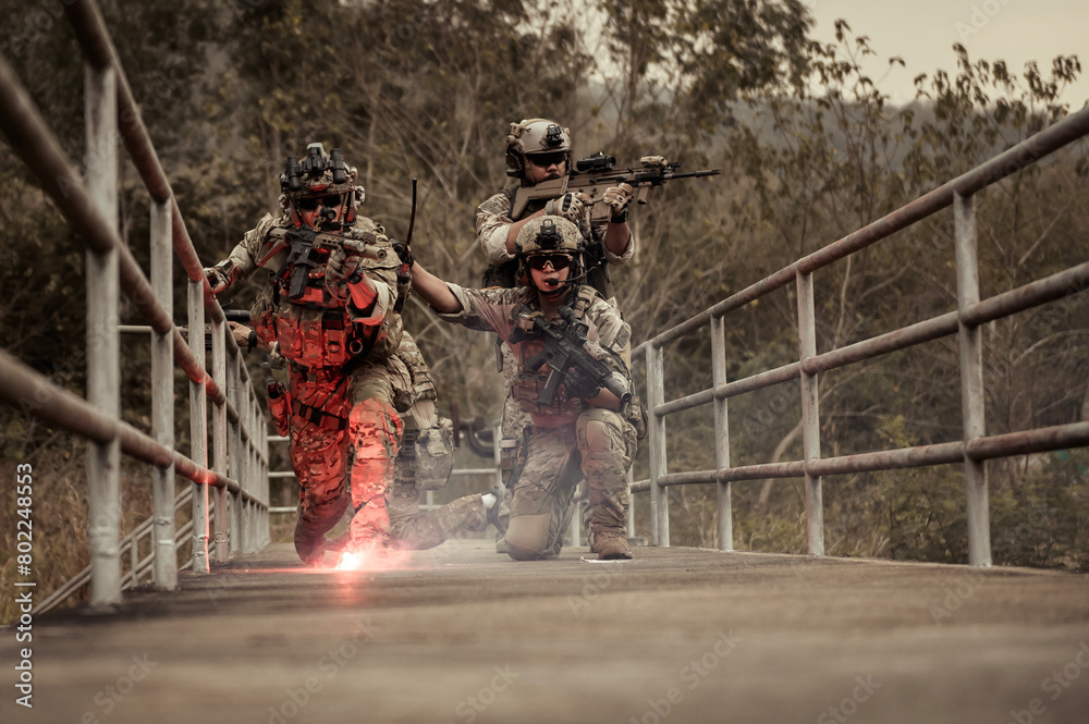 Soldiers in camouflage uniforms aiming with their rifles.ready to fire ...