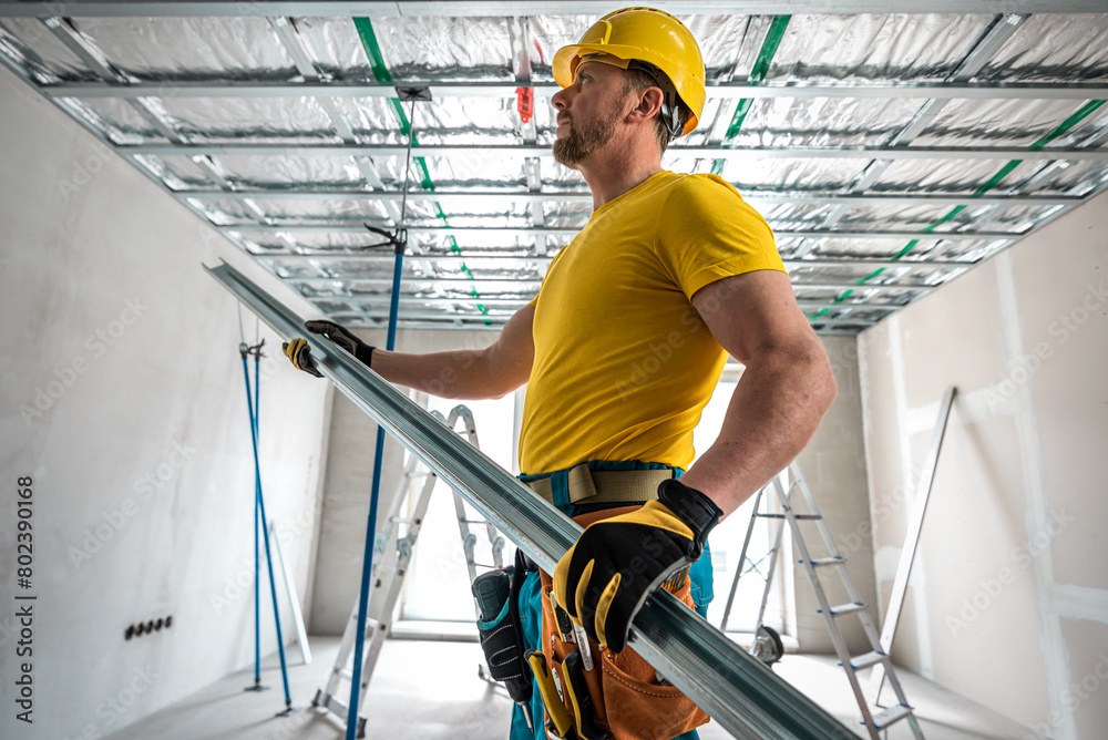 Plasterboard worker making a plasterboard ceiling. Assembling the ...