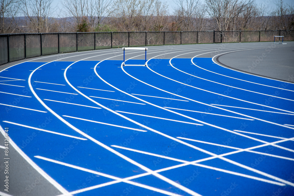 A hurdle on a fresh New athletic track background blue and gray with ...
