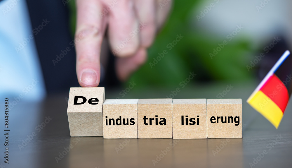 Hand turns wooden cube and changes the German expression ...