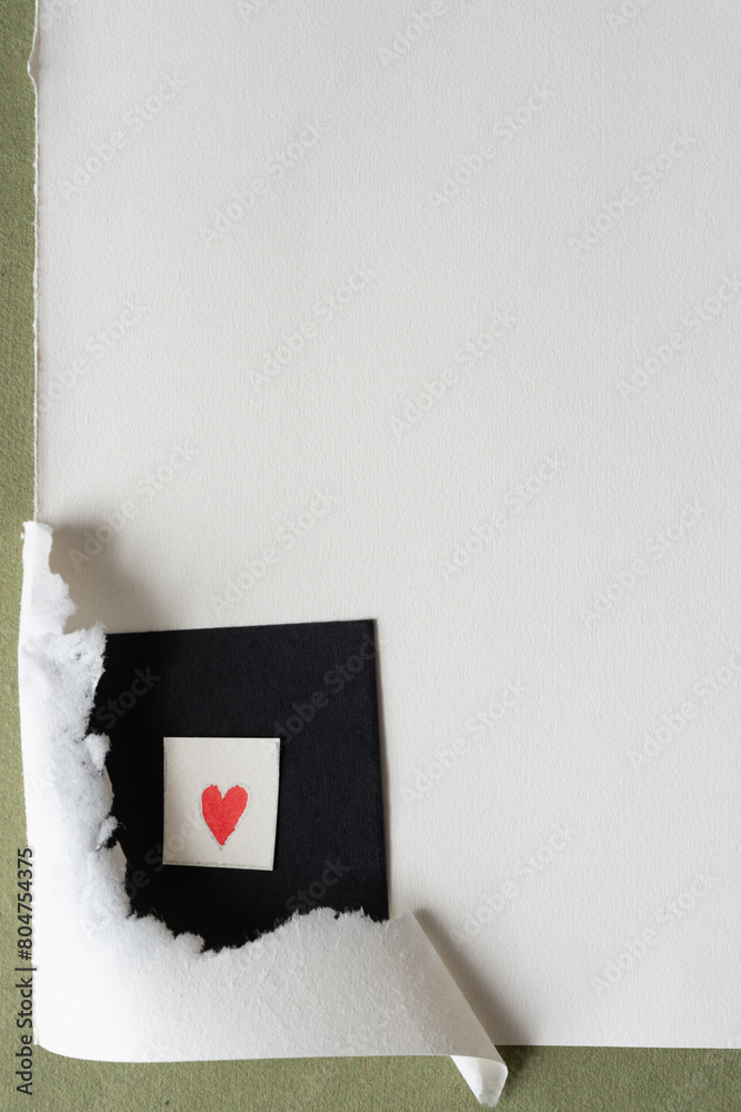 blank paper with a torn curled edge and tucked away in a bottom corner ...