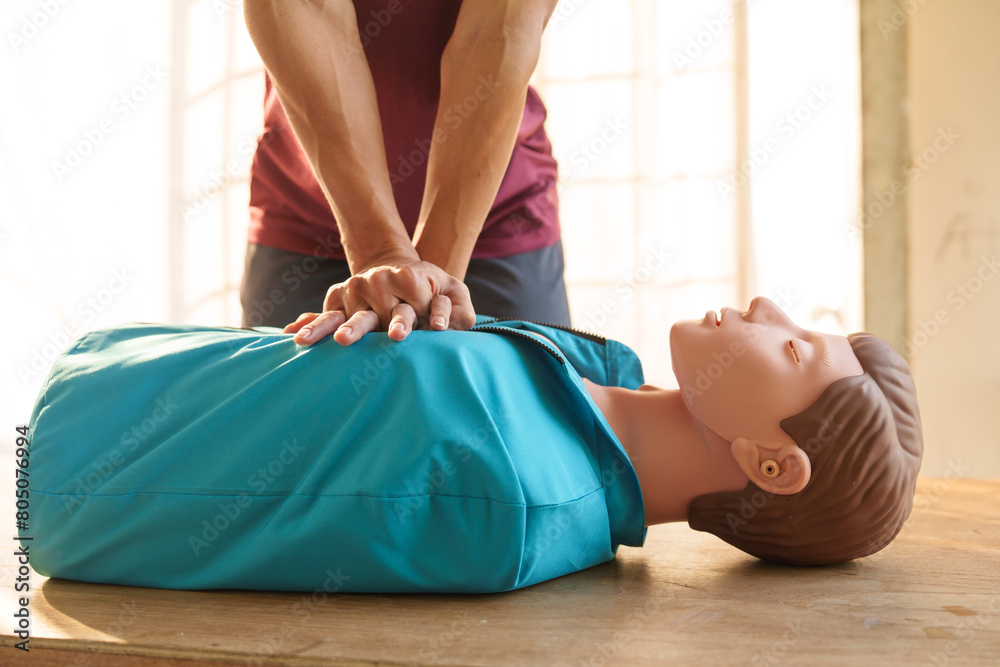 Close-up of middle-aged Asian male hands performing cardiopulmonary ...
