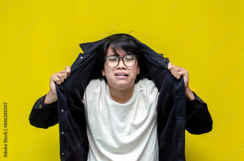 asian man looks depressed and messed up. Irritated man bites lips and ...