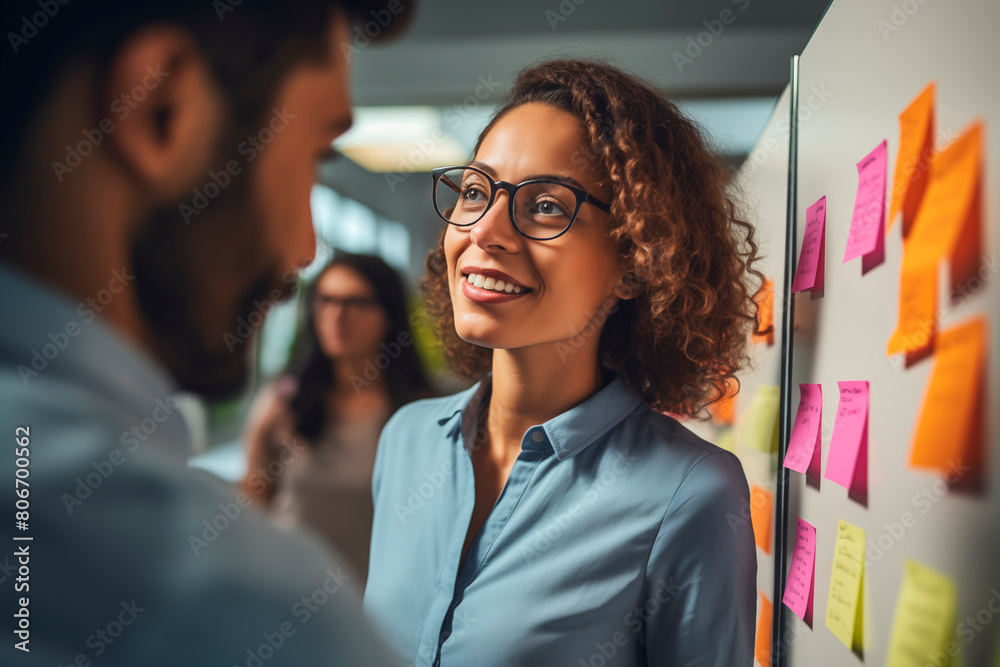 Engaged African American woman leading a team meeting with colorful ...