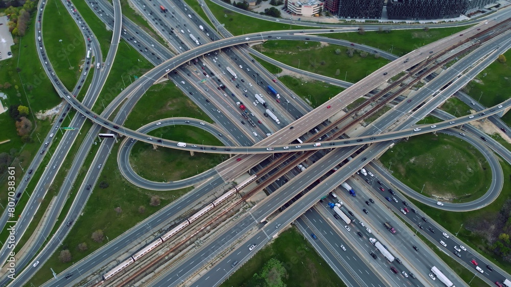 Aerial view of urban highway maze, cars navigate complex interchanges ...