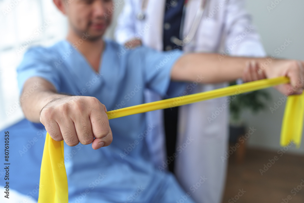 Stock-Foto „Physical therapist gives resistance band exercises. About ...
