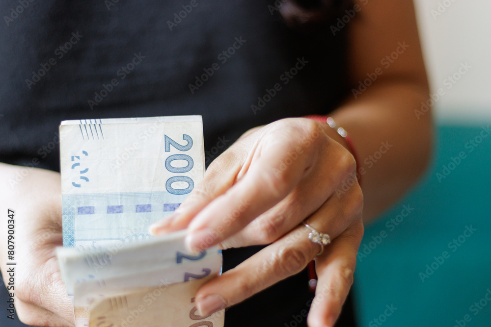 Hand holding Moroccan banknotes, dirham official currency of Morocco ...