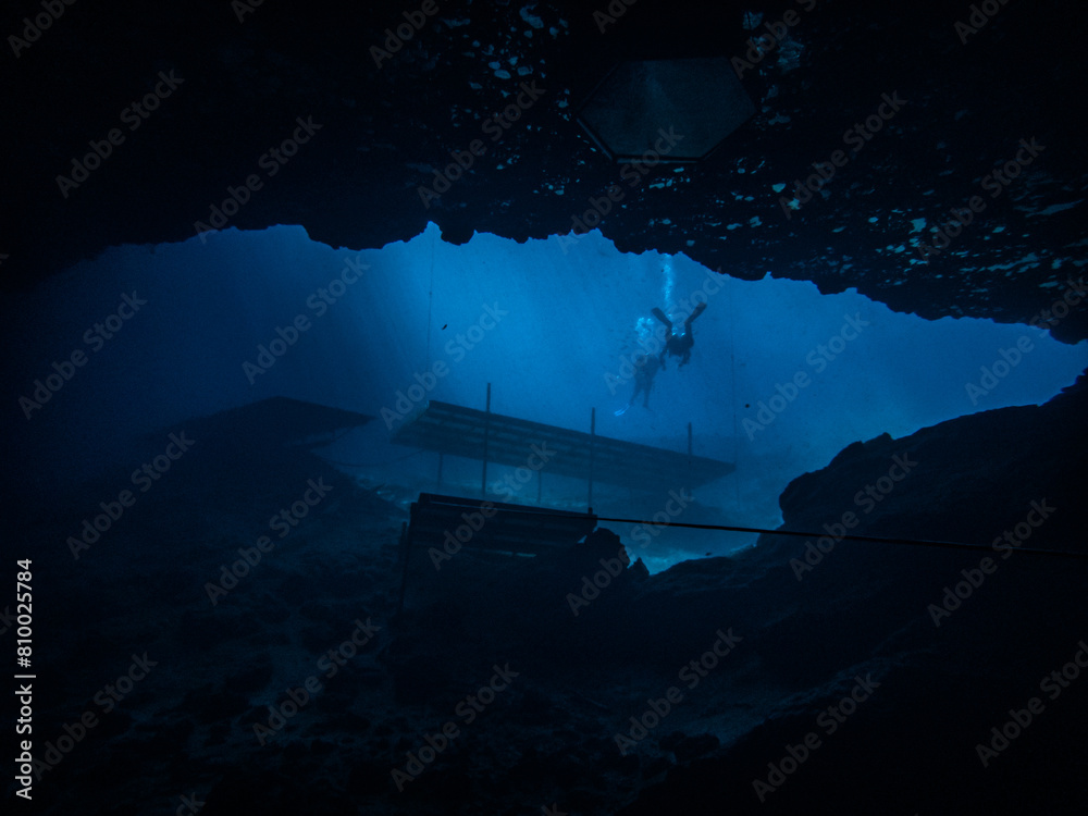 Sunlight illuminating the underwater cavern entrance in the sinkhole at ...