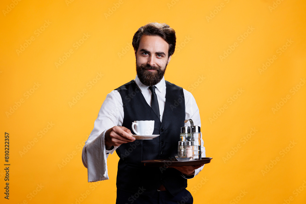 Elegant butler giving coffee cup to clients, pretending to serve people ...