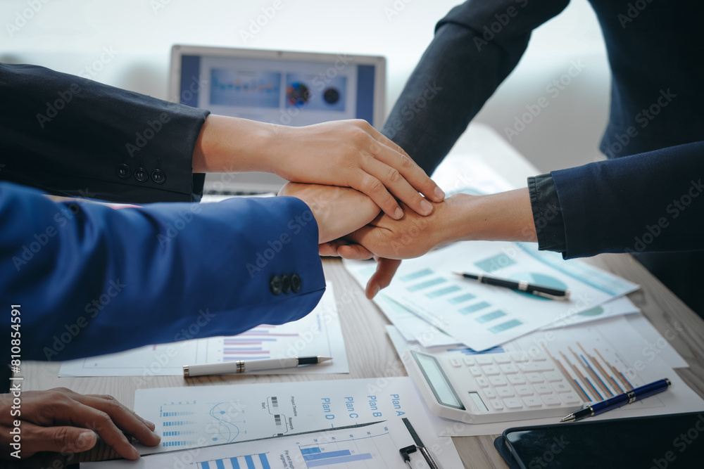 In a business team meeting, success is celebrated with a handshake ...