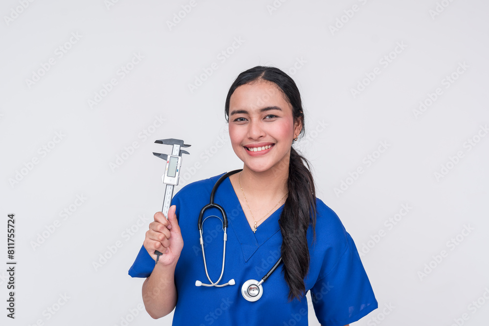 A professional young Asian female nurse dressed in blue scrubs, smiling ...