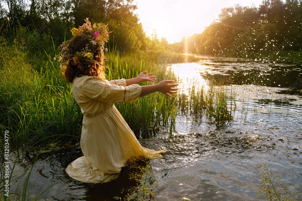 girl in flower wreath stand in river. summer nature background. Floral ...