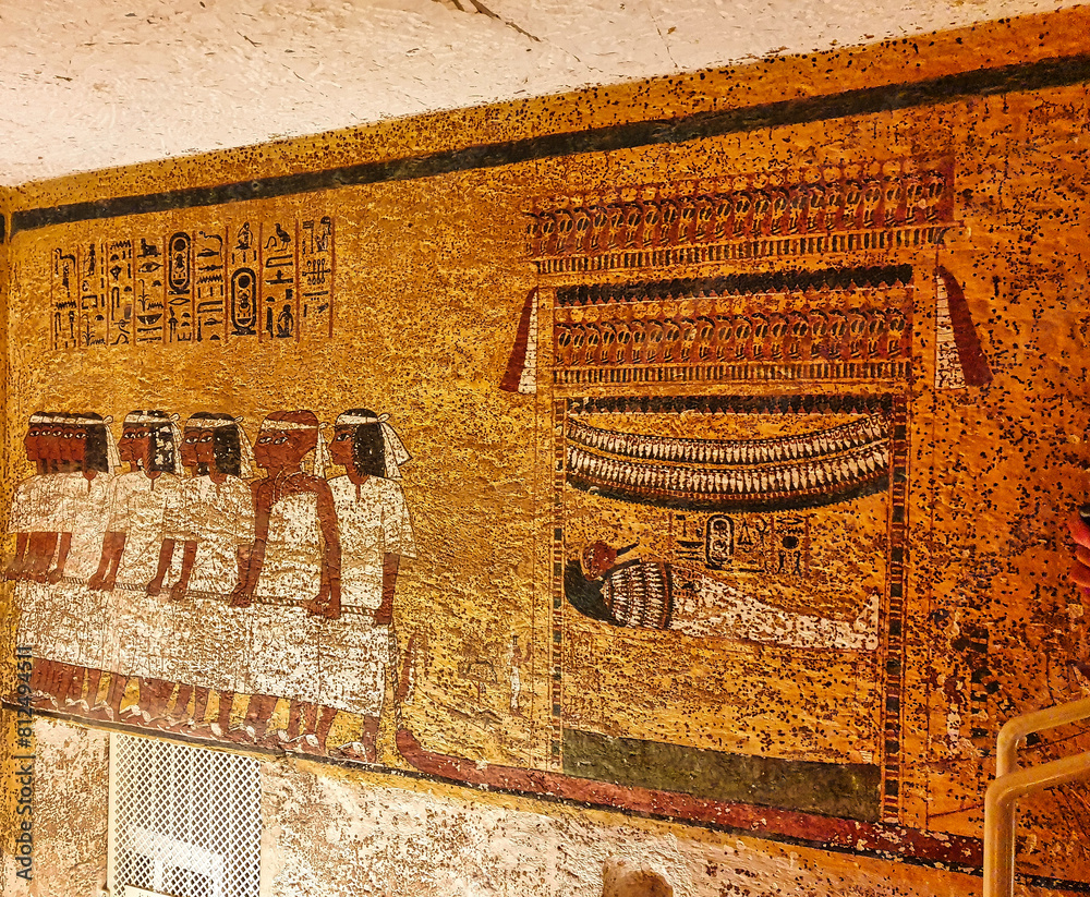 Wall relief depicting Pharoah Tutankhamun's mummy being dragged by ...