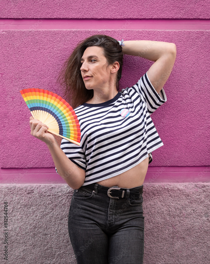 Transgender woman with rainbow fan posing sexy on pink. Concept of ...