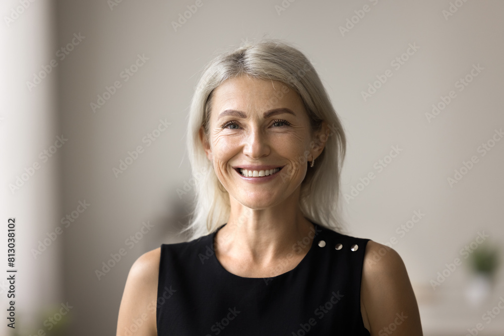 Positive attractive blonde senior woman posing for shooting with ...