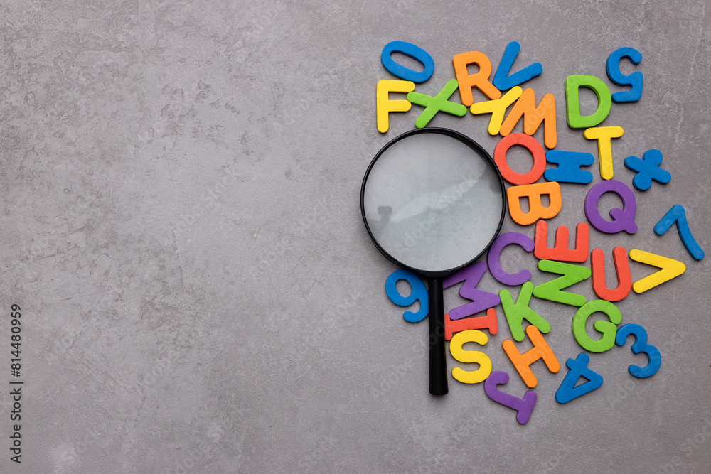 Magnifying glass with many wood letters of English alphabets, learning ...